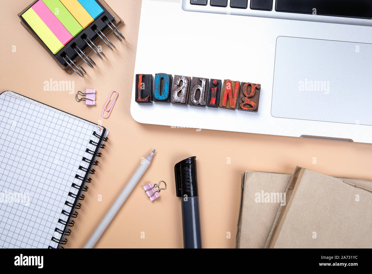 Loading word made from colorful wooden alphabet letters. Computer ...