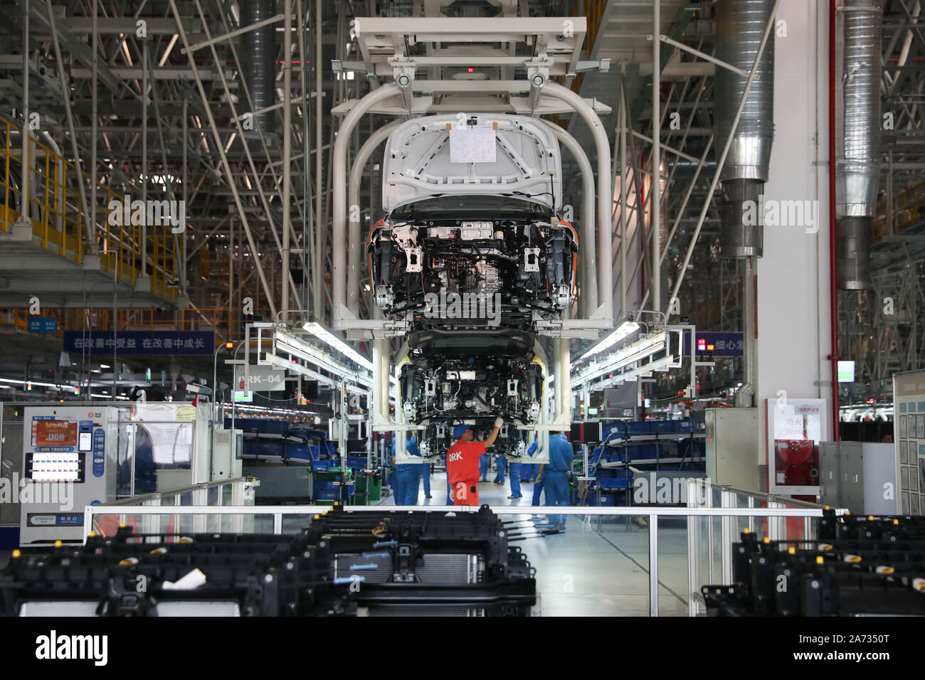 Shanghai. 29th Oct, 2019. Staff members work at a production line of ...
