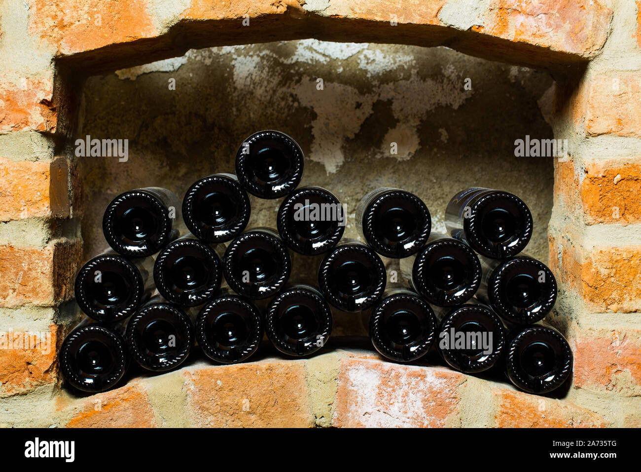 Wine bottles in the brick shelf Stock Photo - Alamy