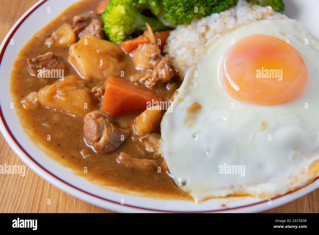 Chicken curry Rice on wooden background ( Poached egg, Potato, enoki ...