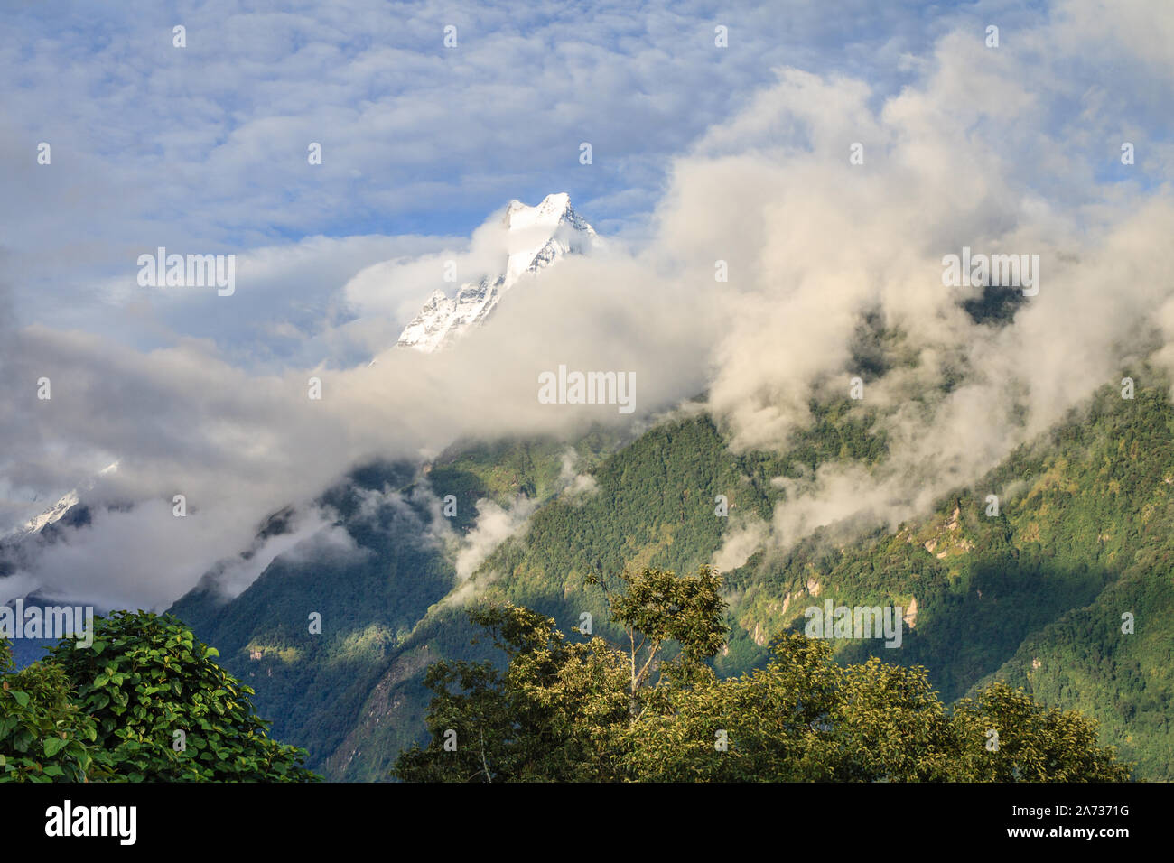 View of Annapurna Himalayas range and Fishtail (Machapuchare) mountain in the clouds. Nepal ...