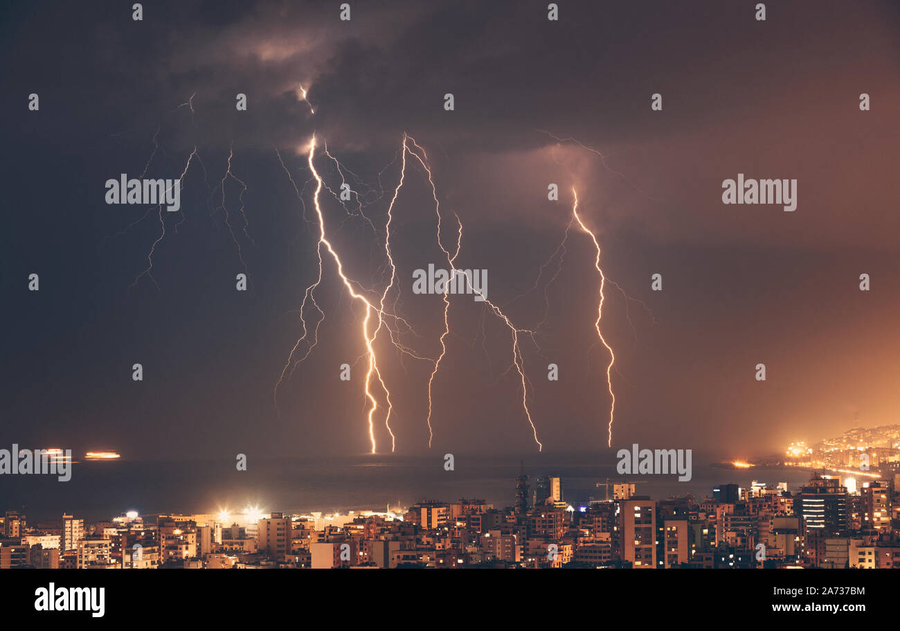 Beautiful lightning over night city, amazing cityscape with many bright ...