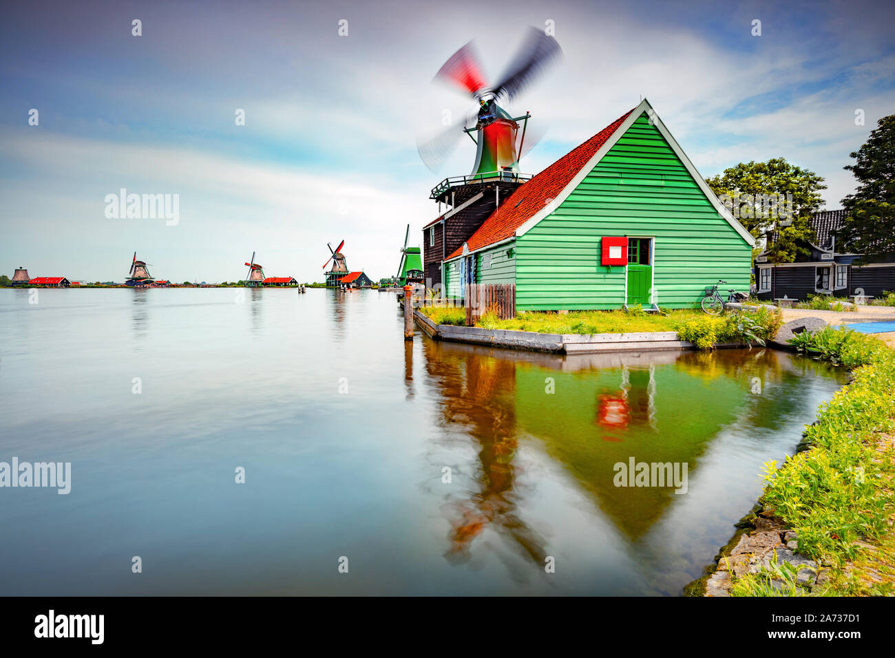 Nice colorful windmills on the bank of a river, the traditional view of ...