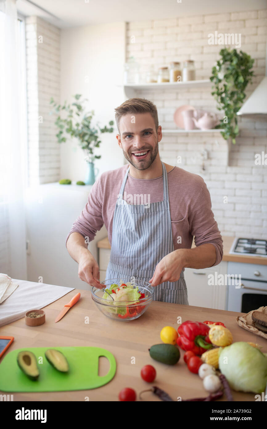Man feeling amazing while cooking in the kitchen Stock Photo - Alamy