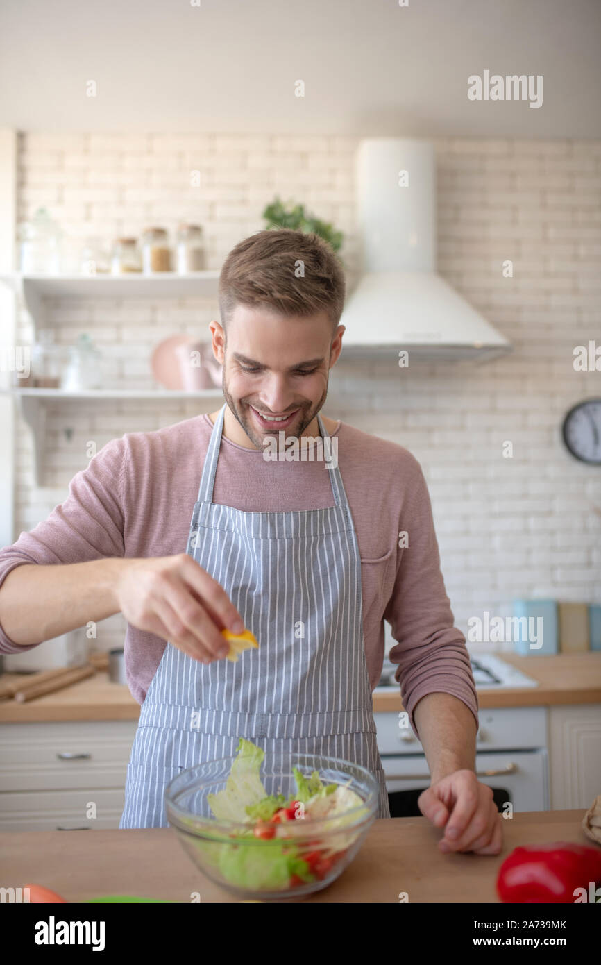 Man feeling excited before eating salad while cooking Stock Photo - Alamy