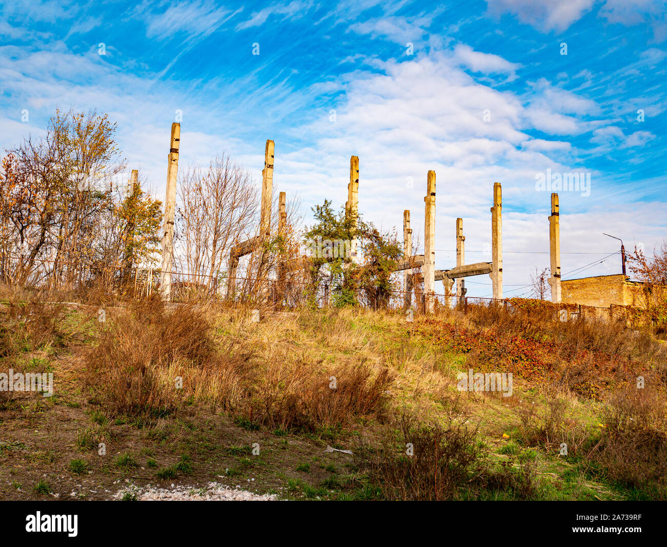Abandoned construction site on a background of blue sky with clouds ...
