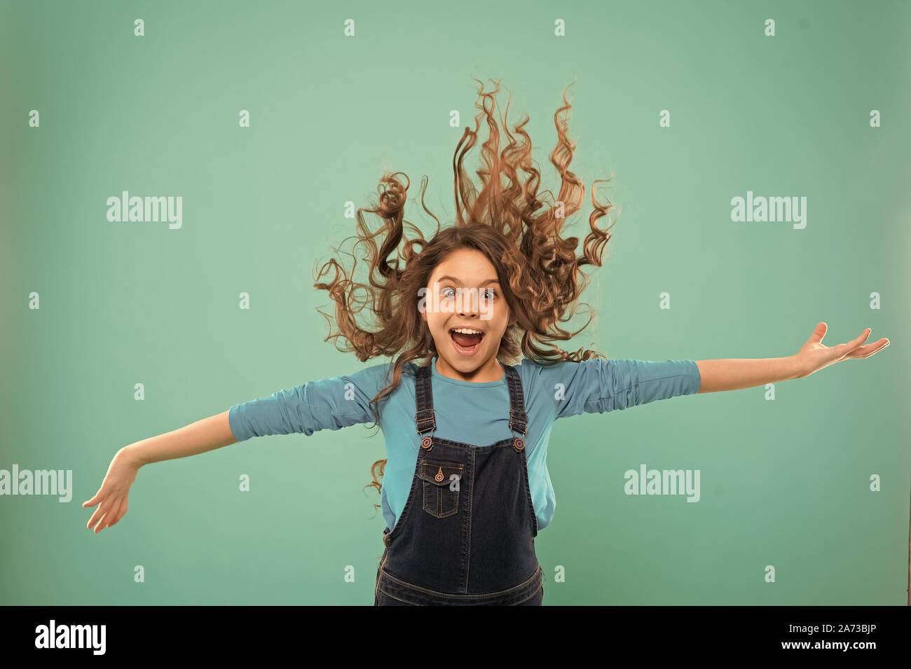 Feeling active and energetic. Energetic little girl with long brunette ...