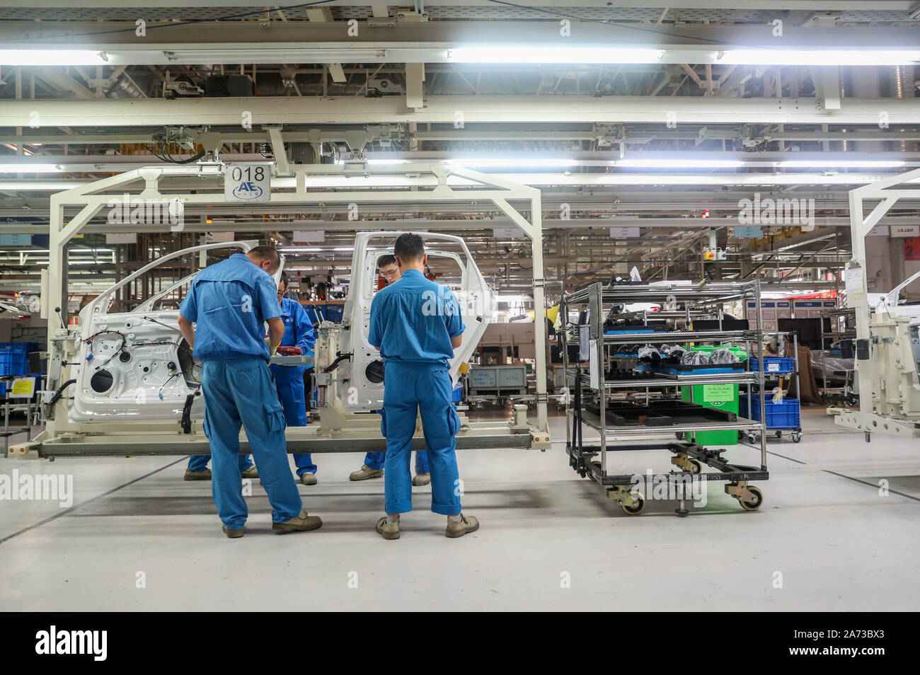 Shanghai. 29th Oct, 2019. Staff members work at a production line of ...