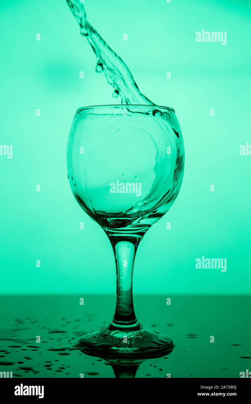 splashing in a glass of clean drinking water on a black glass table on ...