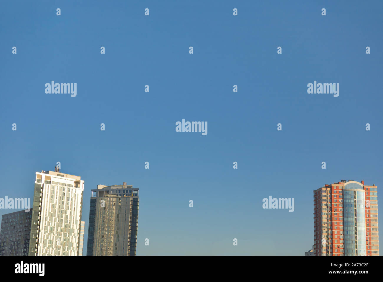 Group of skyscrapers or flat block buildings on clear blue sky ...