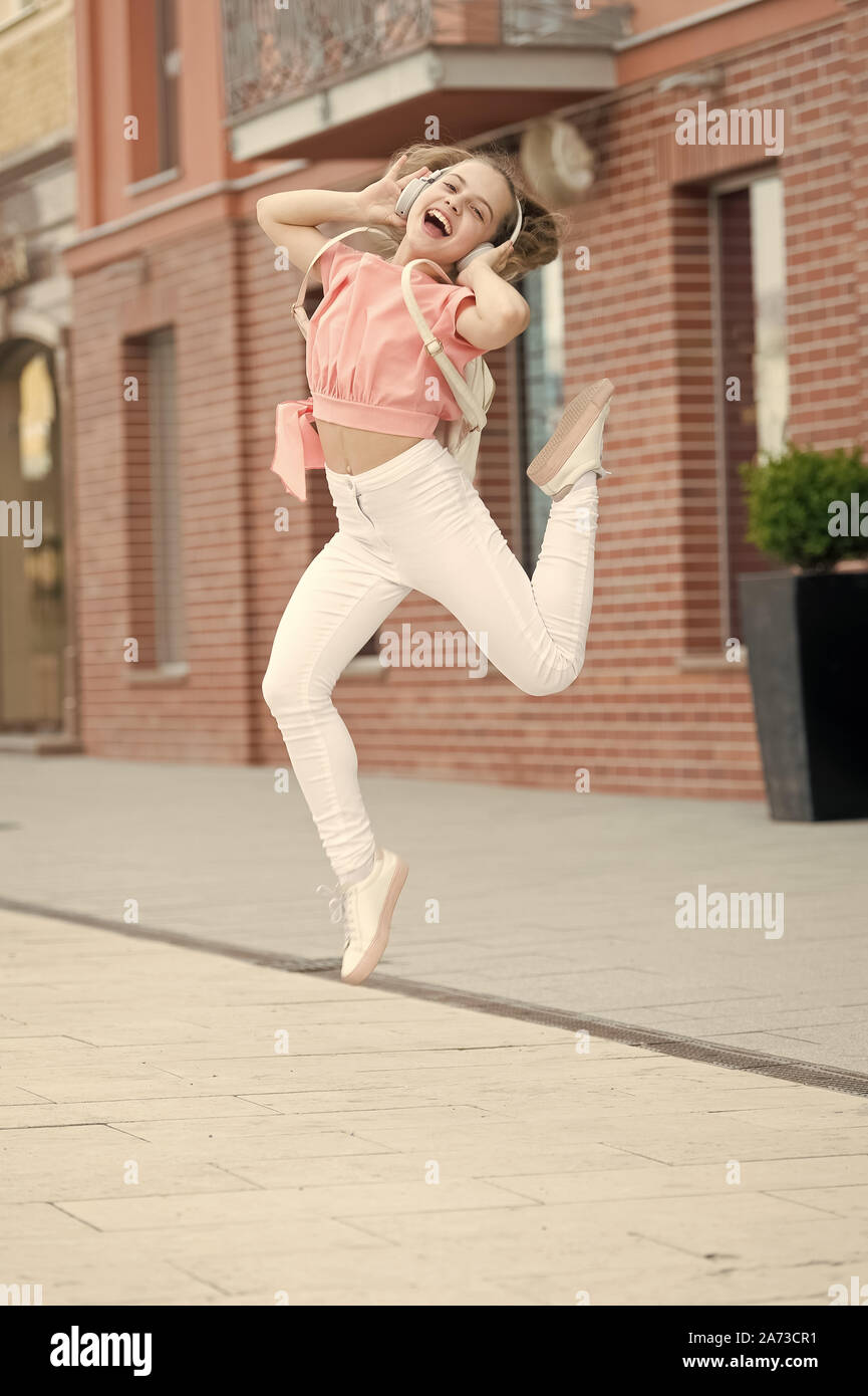 Dancing cutie. Adorable dancer moving to music on city street. Small ...