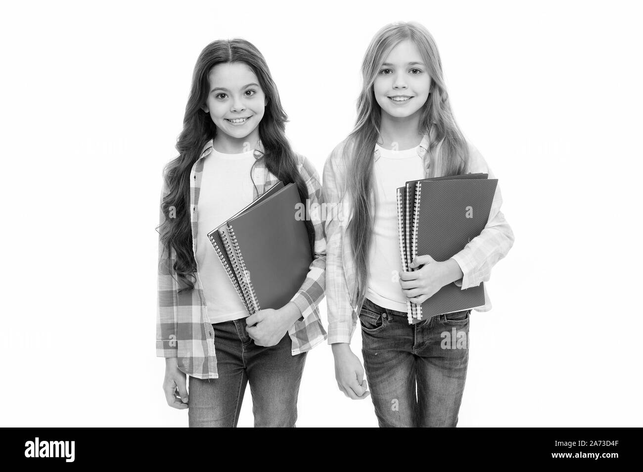 Taking extra classes. Happy to be students. Girls with school textbooks ...