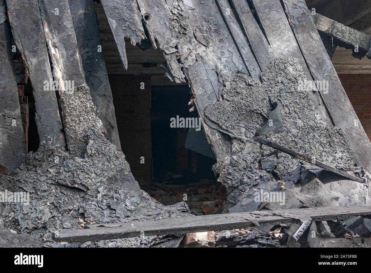 Burnt boards from a collapsed roof during a fire. Fire aftermath Stock ...