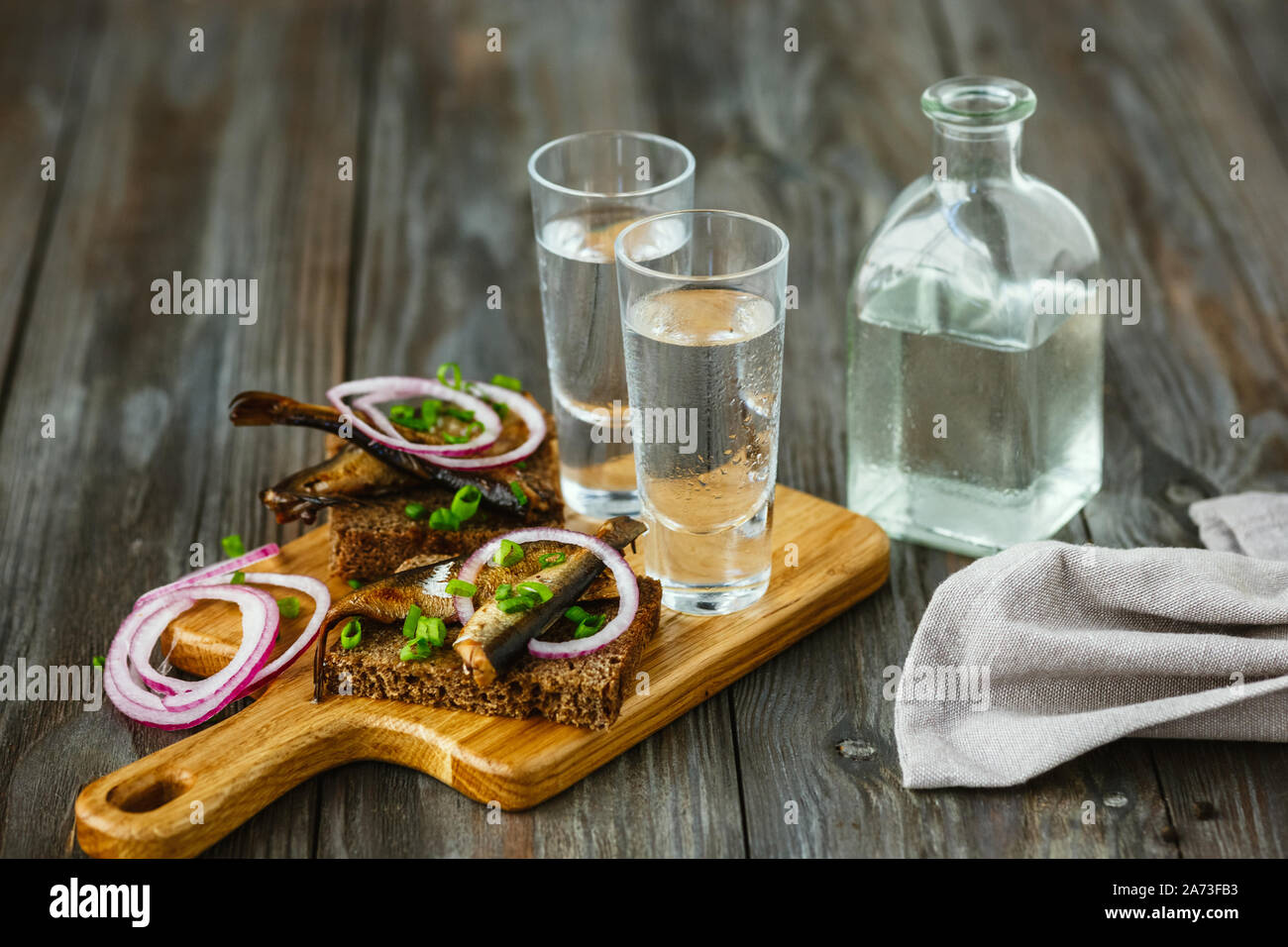 Vodka with fish and bread toast on wooden background. Alcohol pure ...