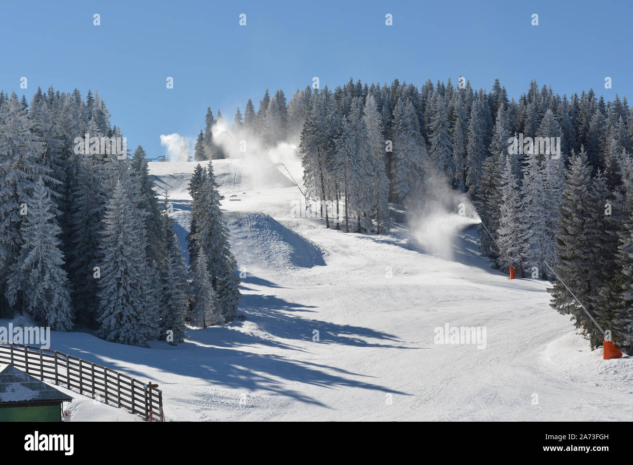 The end of ski day, several snow guns in action, overlapping of ski ...