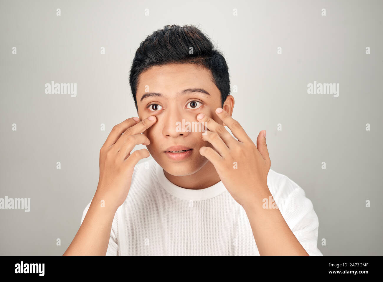 Closeup portrait of smiling adult Asian business man pointing to his ...