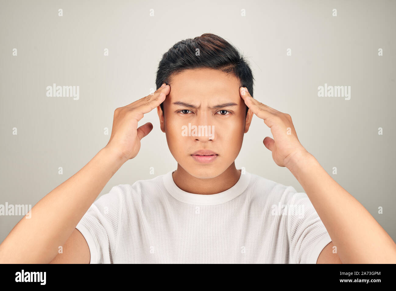 People, stress, tension and migraine concept. Upset unhappy young man ...