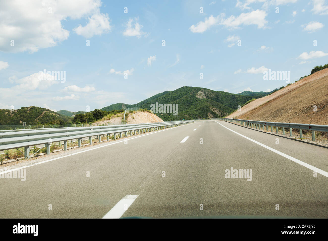 Freedom travel concept. An empty freeway through rural landscape with ...