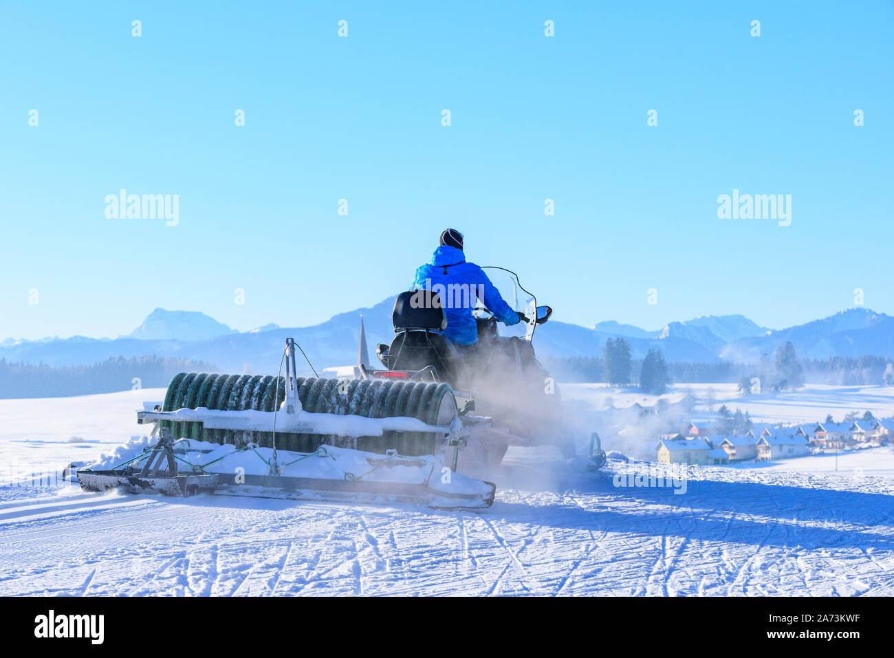 Preparation of cc-track with a skidoo and tracking device Stock Photo ...