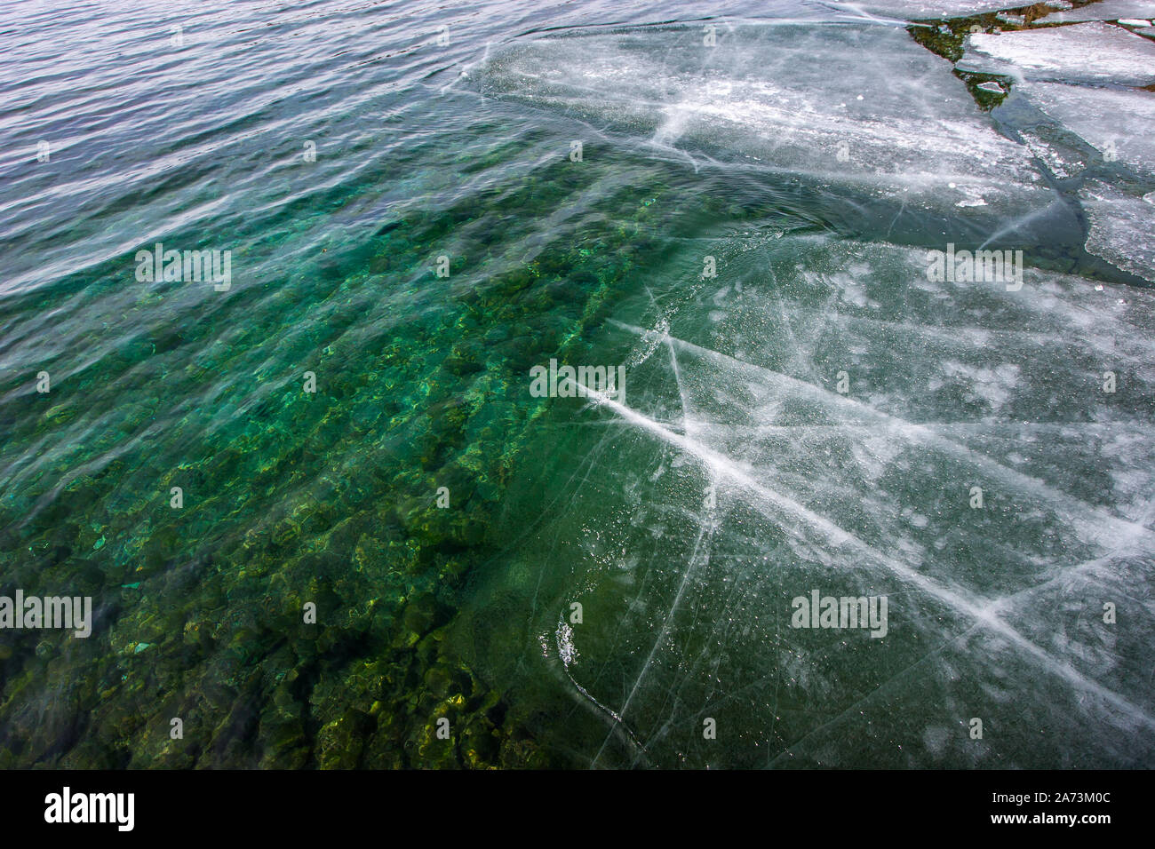 Texture of water and floating ice. Turquoise water with waves and white ...