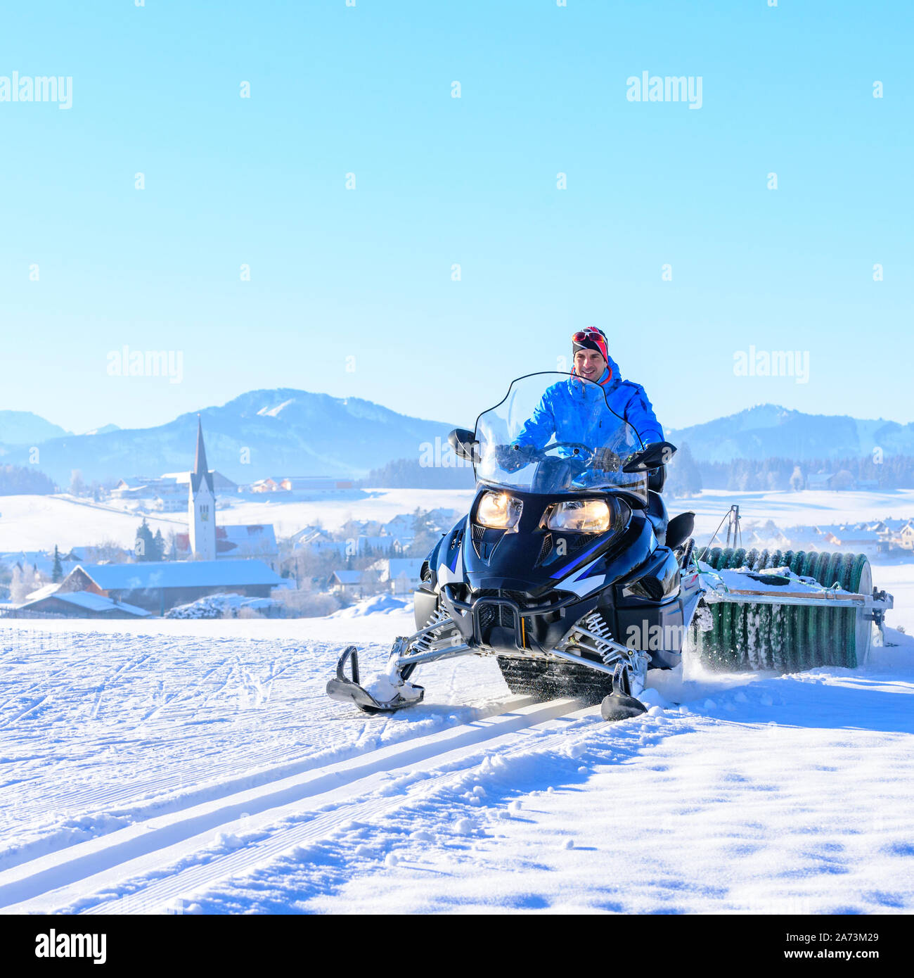 Preparation of cc-track with a skidoo and tracking device Stock Photo ...