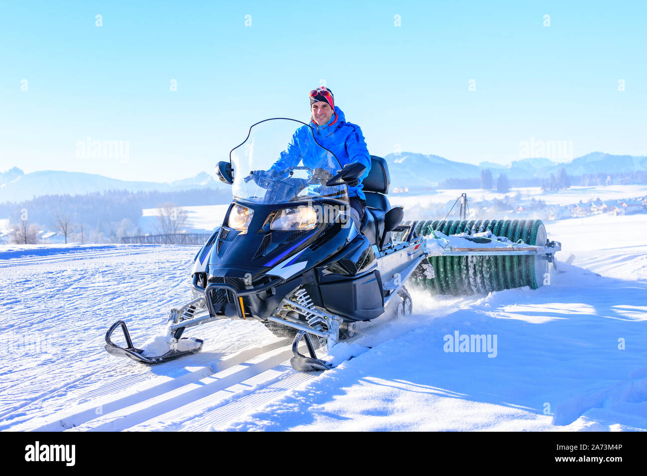 Preparation of cc-track with a skidoo and tracking device Stock Photo ...