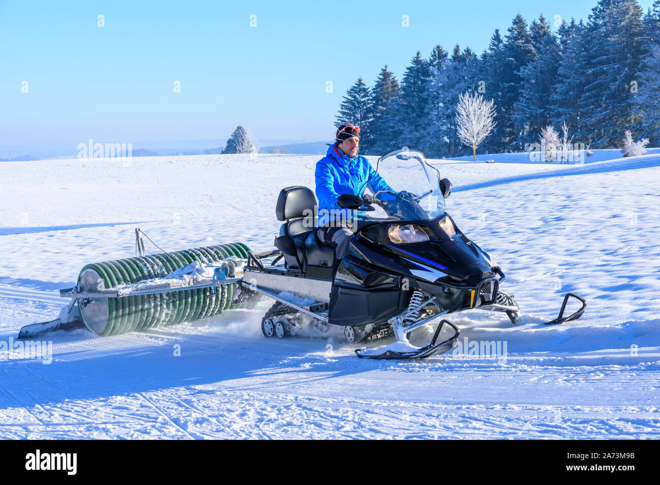 Preparation of cc-track with a skidoo and tracking device Stock Photo ...