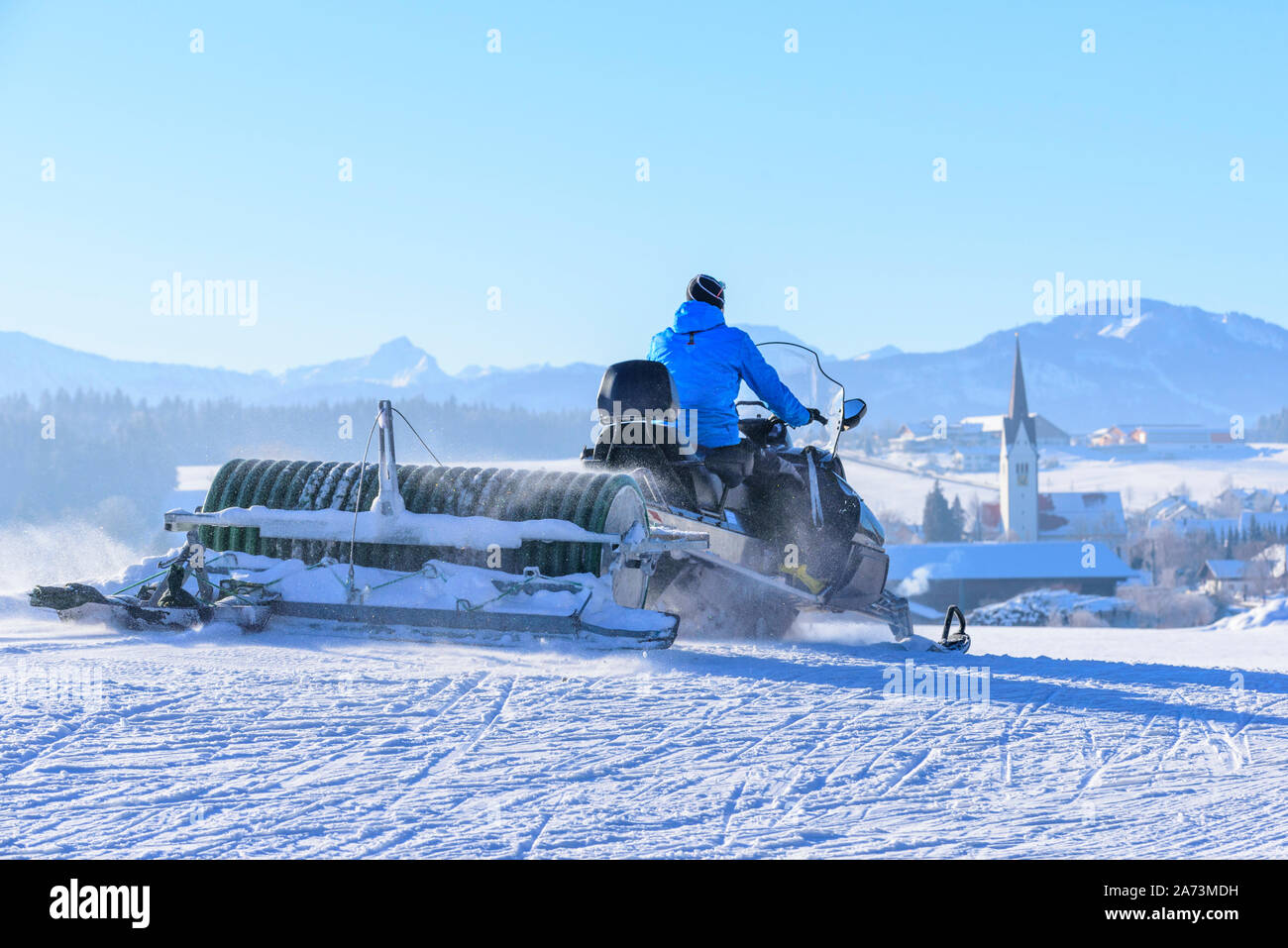 Preparation of cc-track with a skidoo and tracking device Stock Photo ...