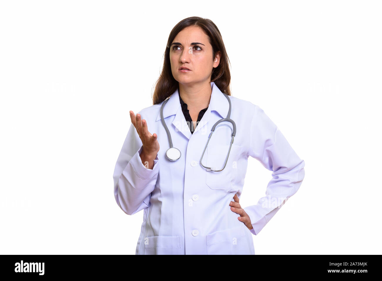Studio shot of angry woman doctor thinking while looking up Stock Photo ...