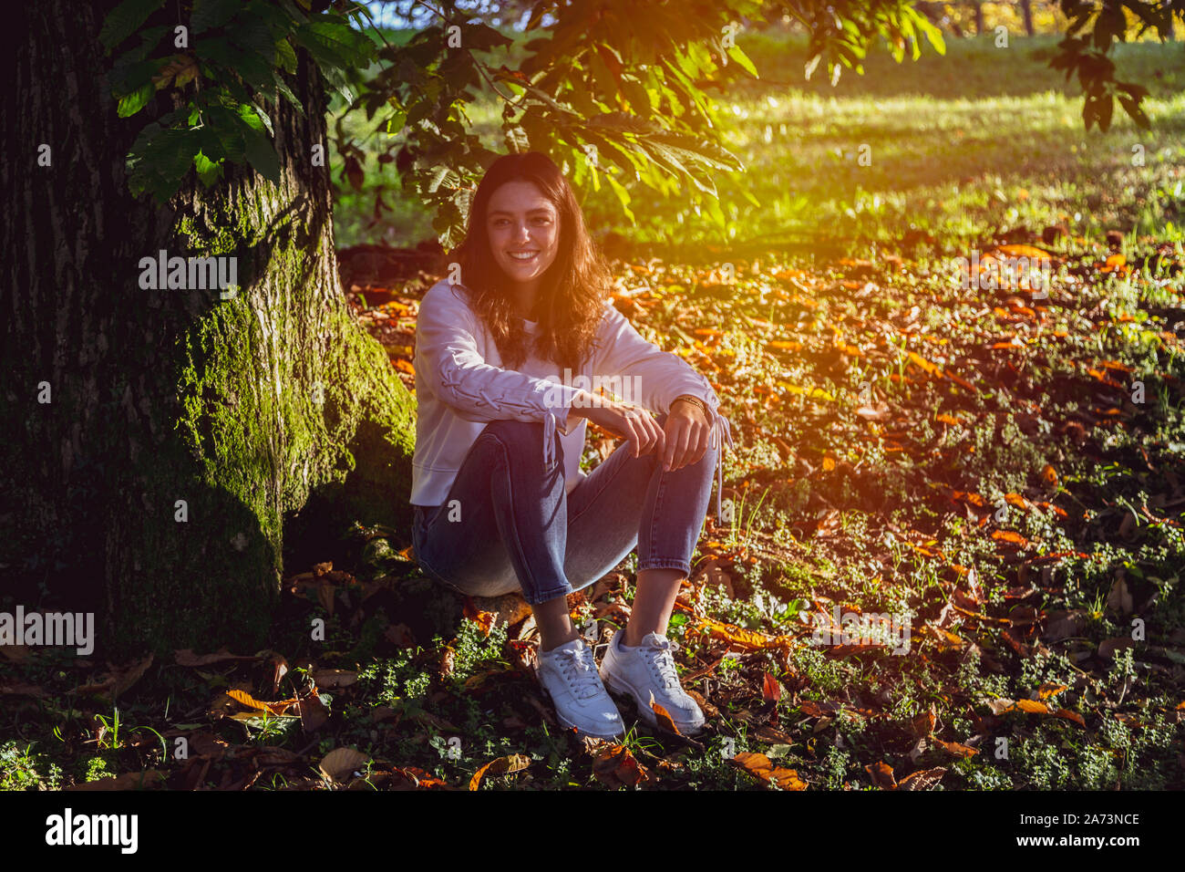 Female sitting under a tree hi-res stock photography and images - Alamy