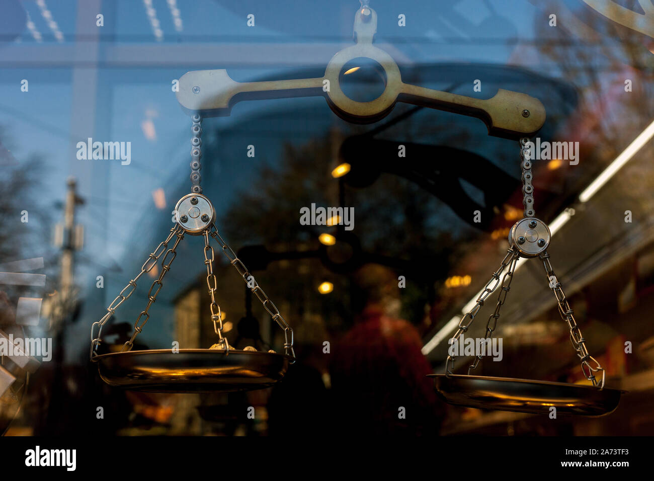 Small metal unbalanced scales. Weighing scale in dark room Stock Photo ...