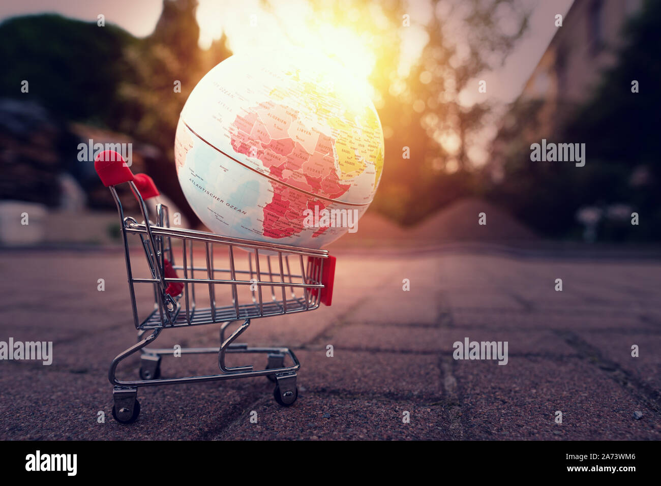 Planet earth in a shopping cart with sun Stock Photo - Alamy