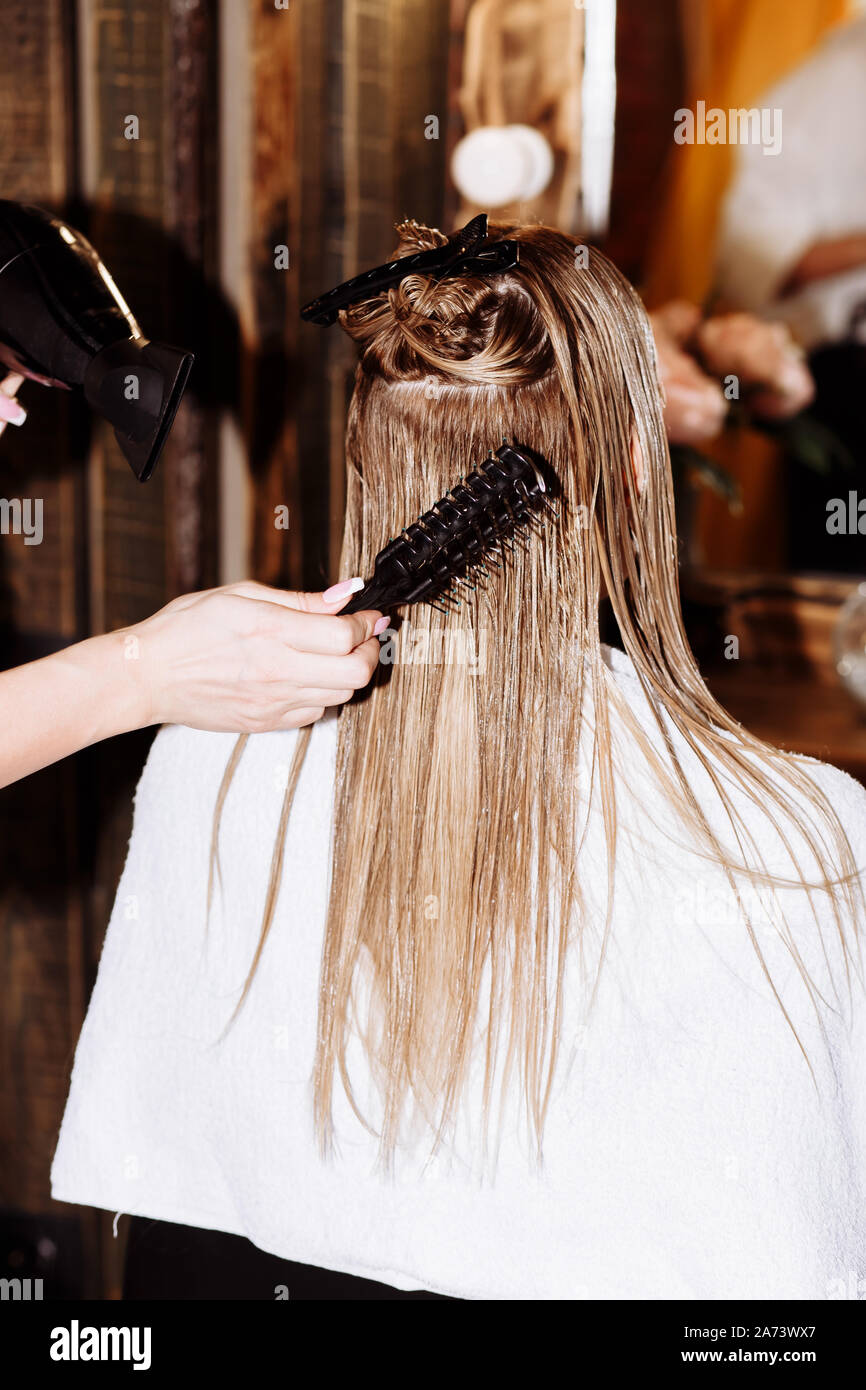 Hairstylist doing hairstyle long hair hi-res stock photography and ...