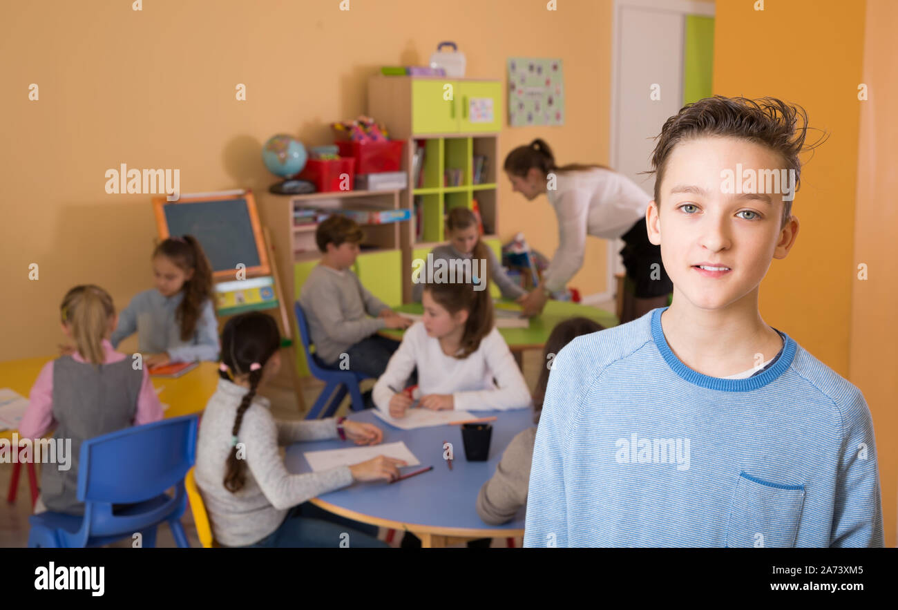 Schoolboy standing, elementary age children drawing at class Stock ...