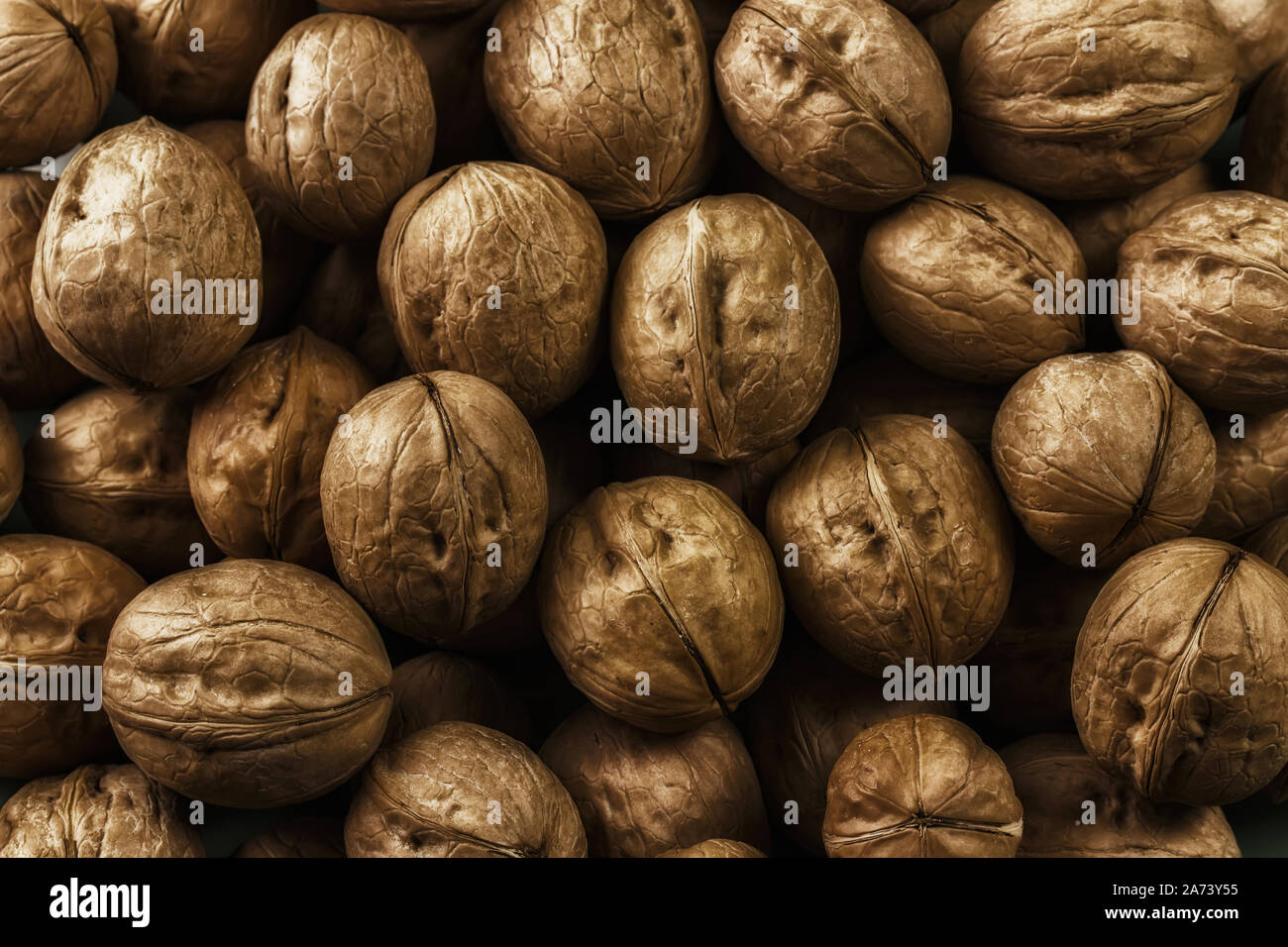 Inshell walnuts, low key close-up. Walnut shell backdrop background ...
