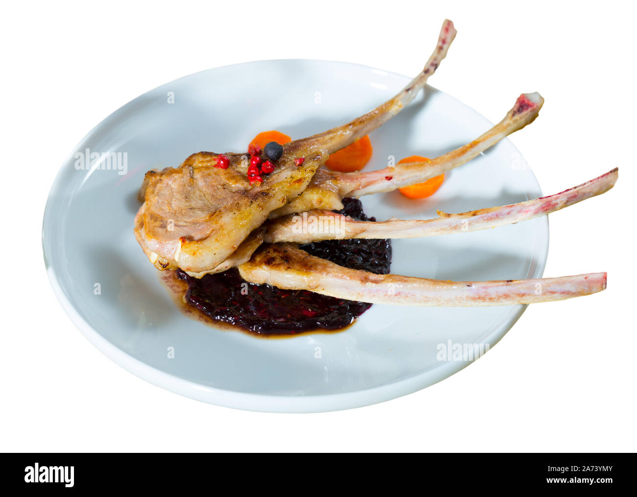 Roasted rack of mutton served with delicious berry sauce and baked ...