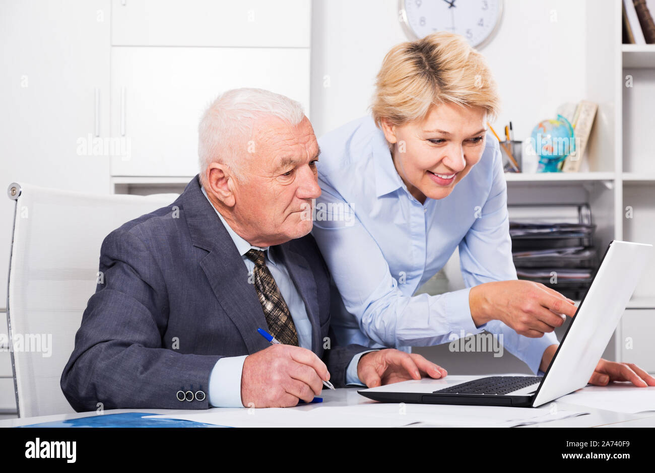 Senior male manager and female secretary working effectively together ...