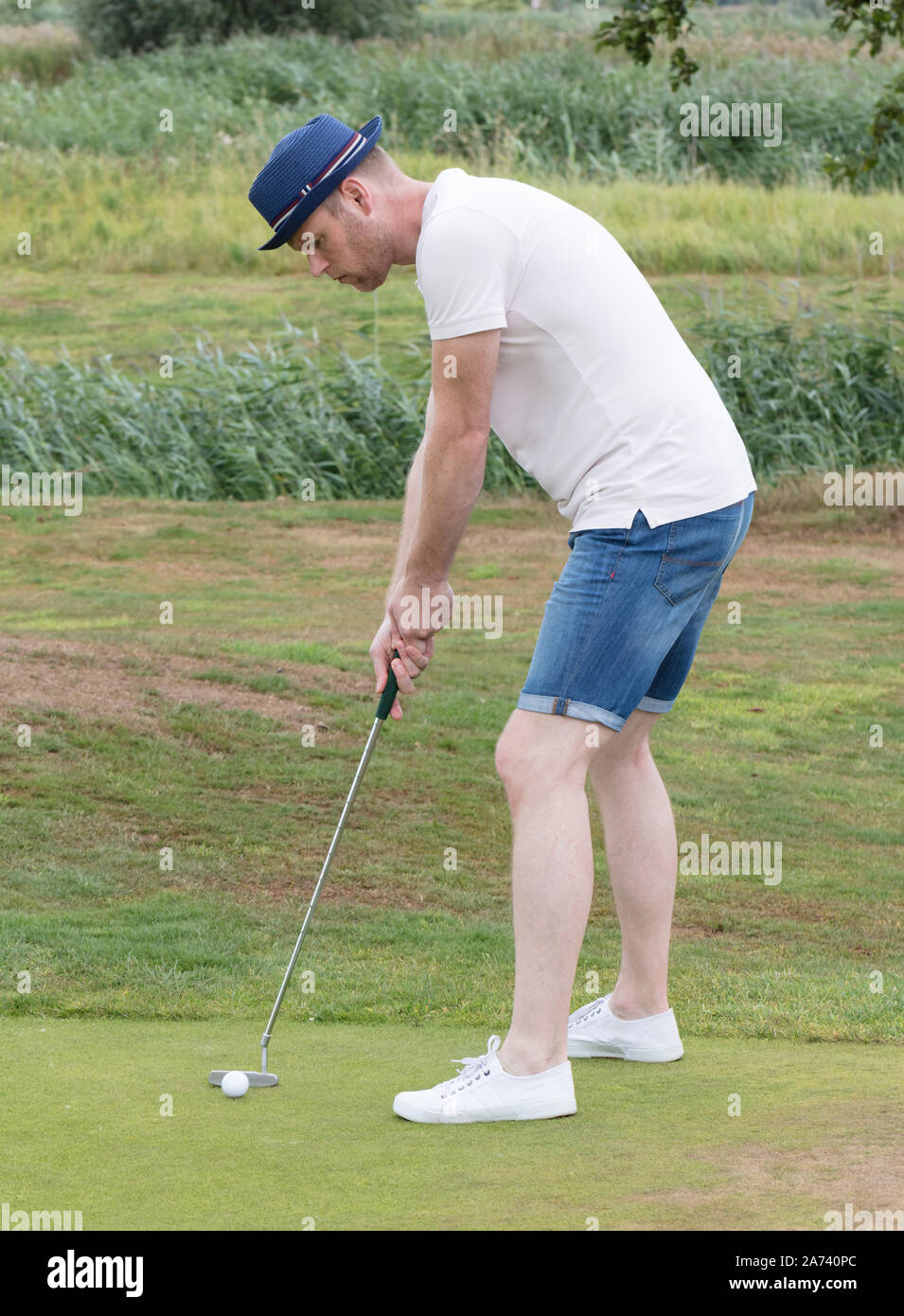 Golfer hit ball on golf course, summertime Stock Photo - Alamy