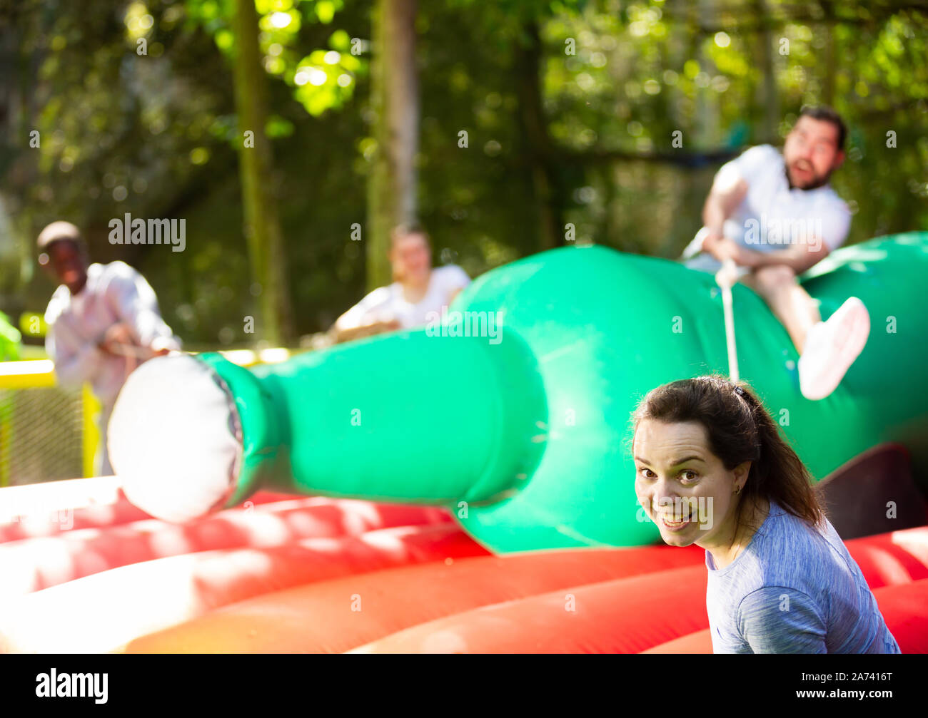 Funny attraction with a huge inflatable bottle in an amusement park ...