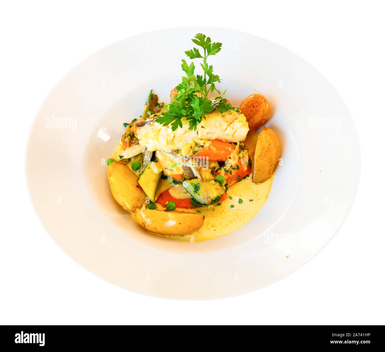 Hake fillet in Spanish style with garnish of baked potatoes, vegetable ...