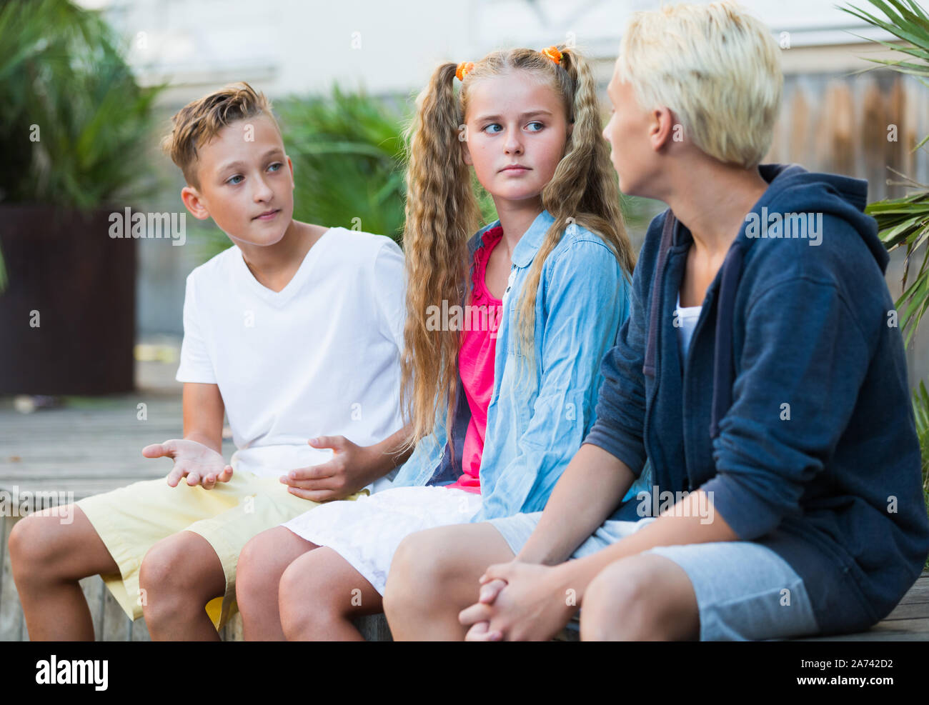 Happy kids funny spending time together outdoors having conversation ...