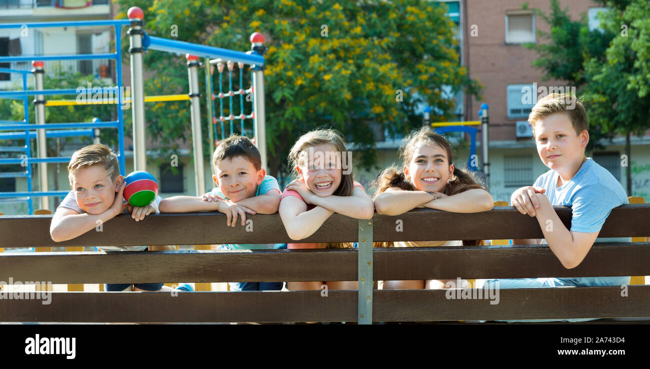 Five children sitting on bench Stock Photo - Alamy