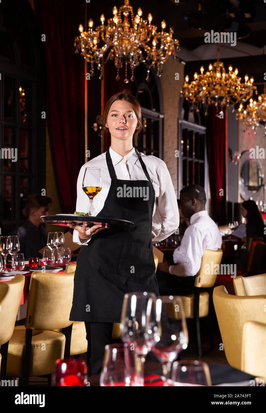 Portrait of smiling waitress with tray at luxury restaurant Stock Photo ...