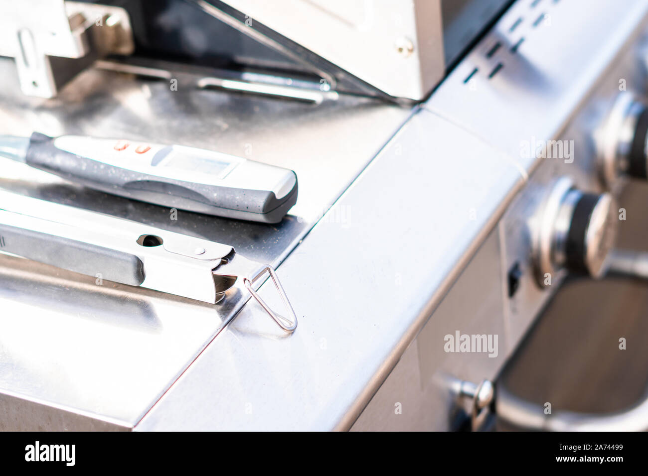 BBQ tools on the side of the outdoor gas grill Stock Photo - Alamy