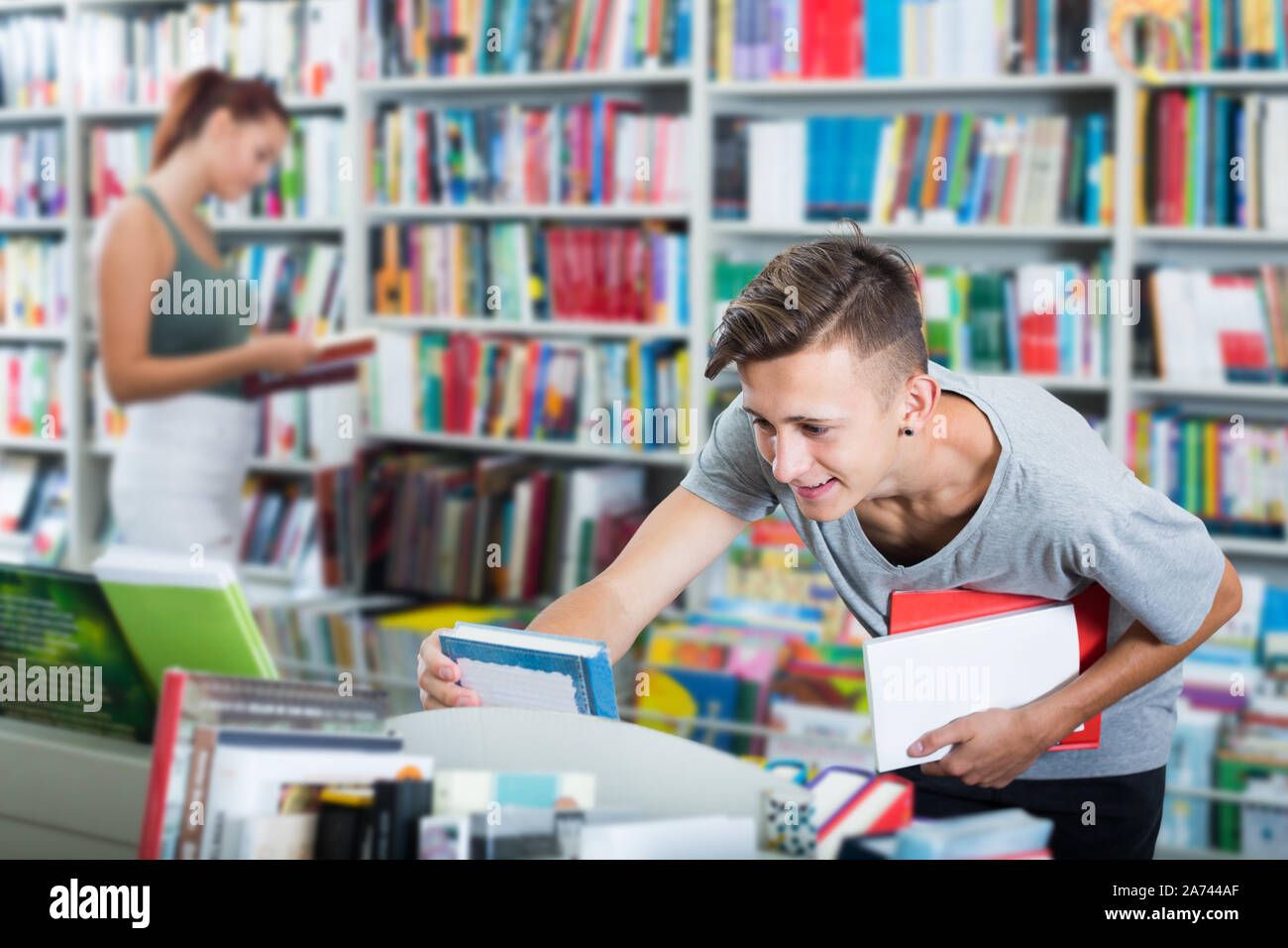 Boy choosing book from library hi-res stock photography and images - Alamy