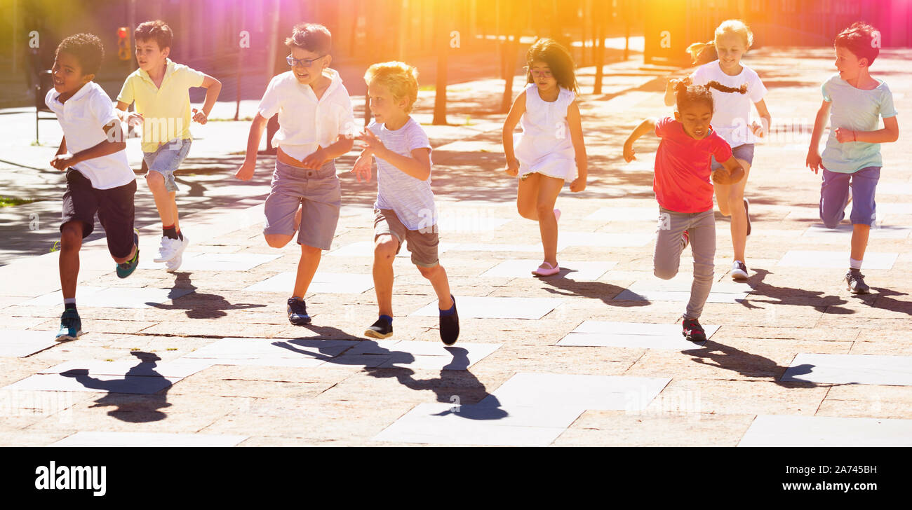 Happy children running in race and laughing outdoors at sunny day Stock ...