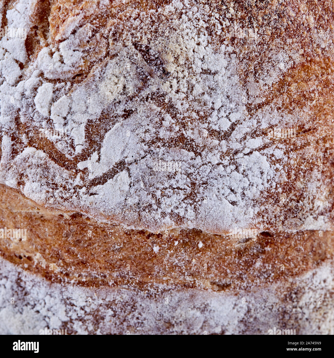 Brown bread top view texture floured. Loaf photo Stock Photo - Alamy