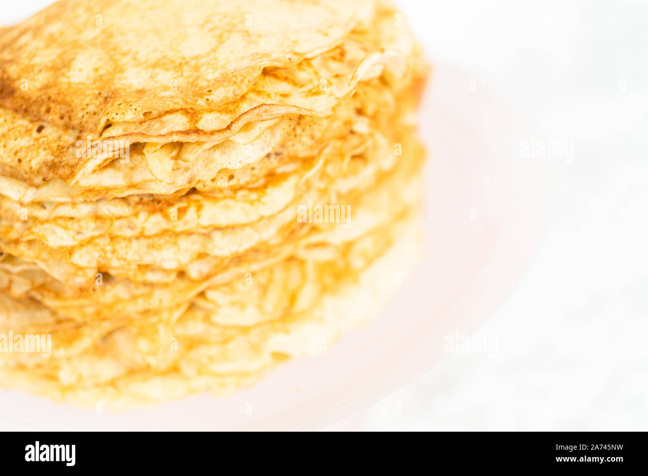Close up. Stack of freshly baked crepes on a cake stand Stock Photo - Alamy