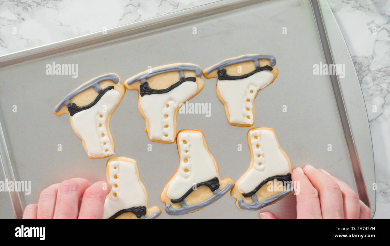 Flat lay. Icing figure skate shaped sugar cookies with royal icing ...