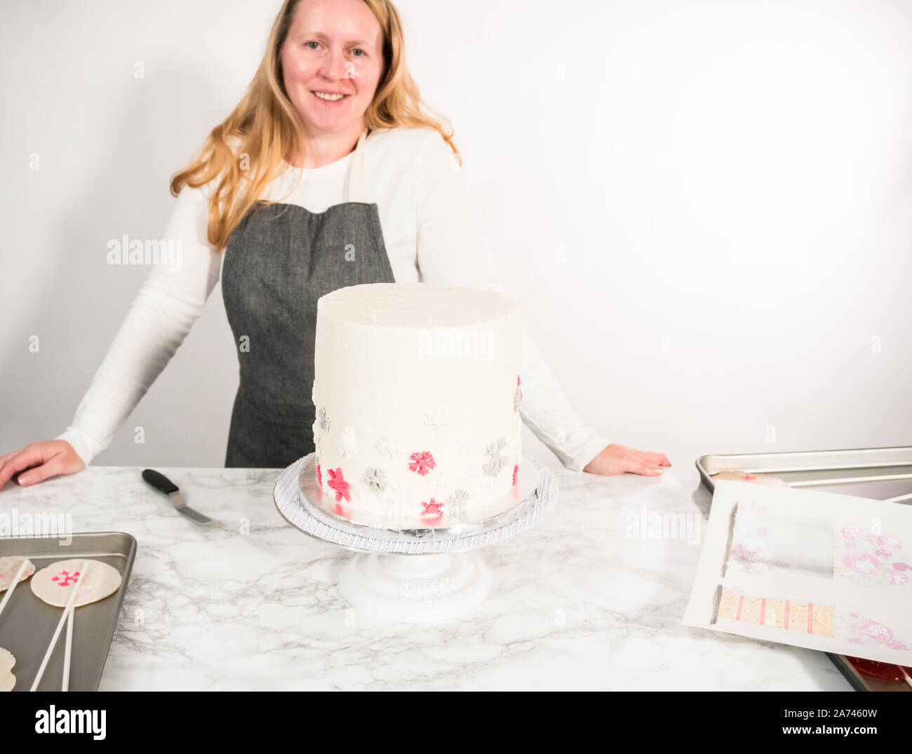 Baking tall round cake with large lollipops for a little girl's ...